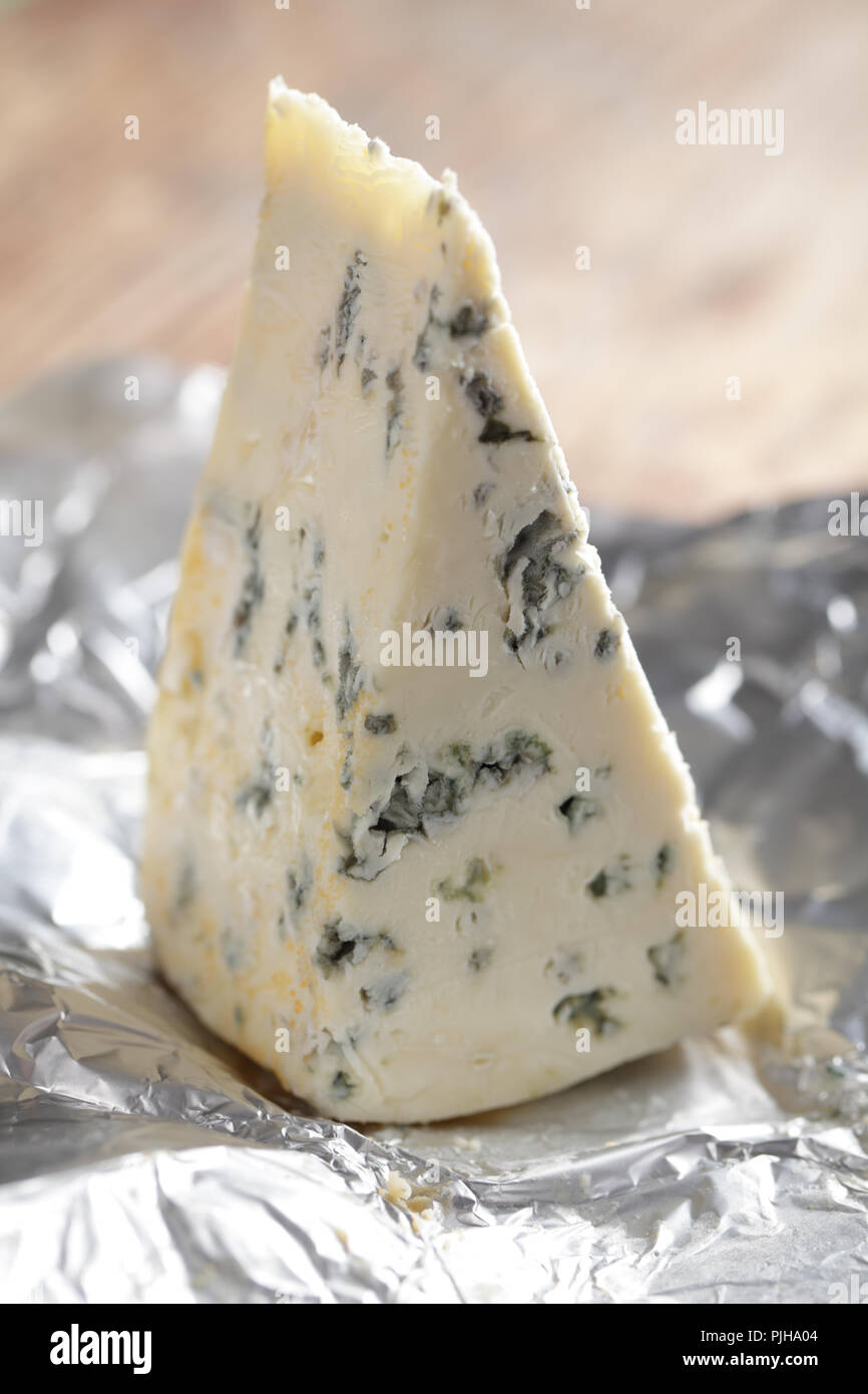 Segment of blue cheese on the aluminium foil Stock Photo - Alamy