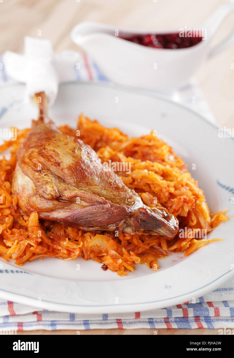 Roasted goose leg with braised cabbage Stock Photo - Alamy