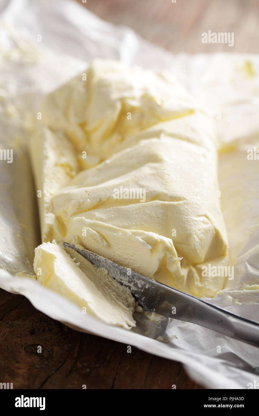 Fresh butter in paper wrap Stock Photo - Alamy