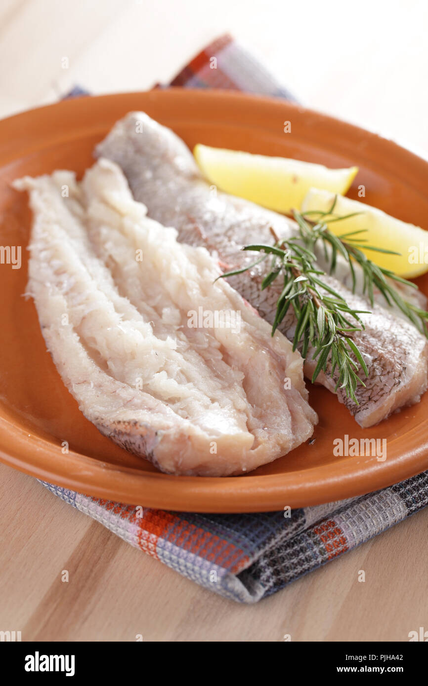 Raw hake fillet on plate hi-res stock photography and images - Alamy