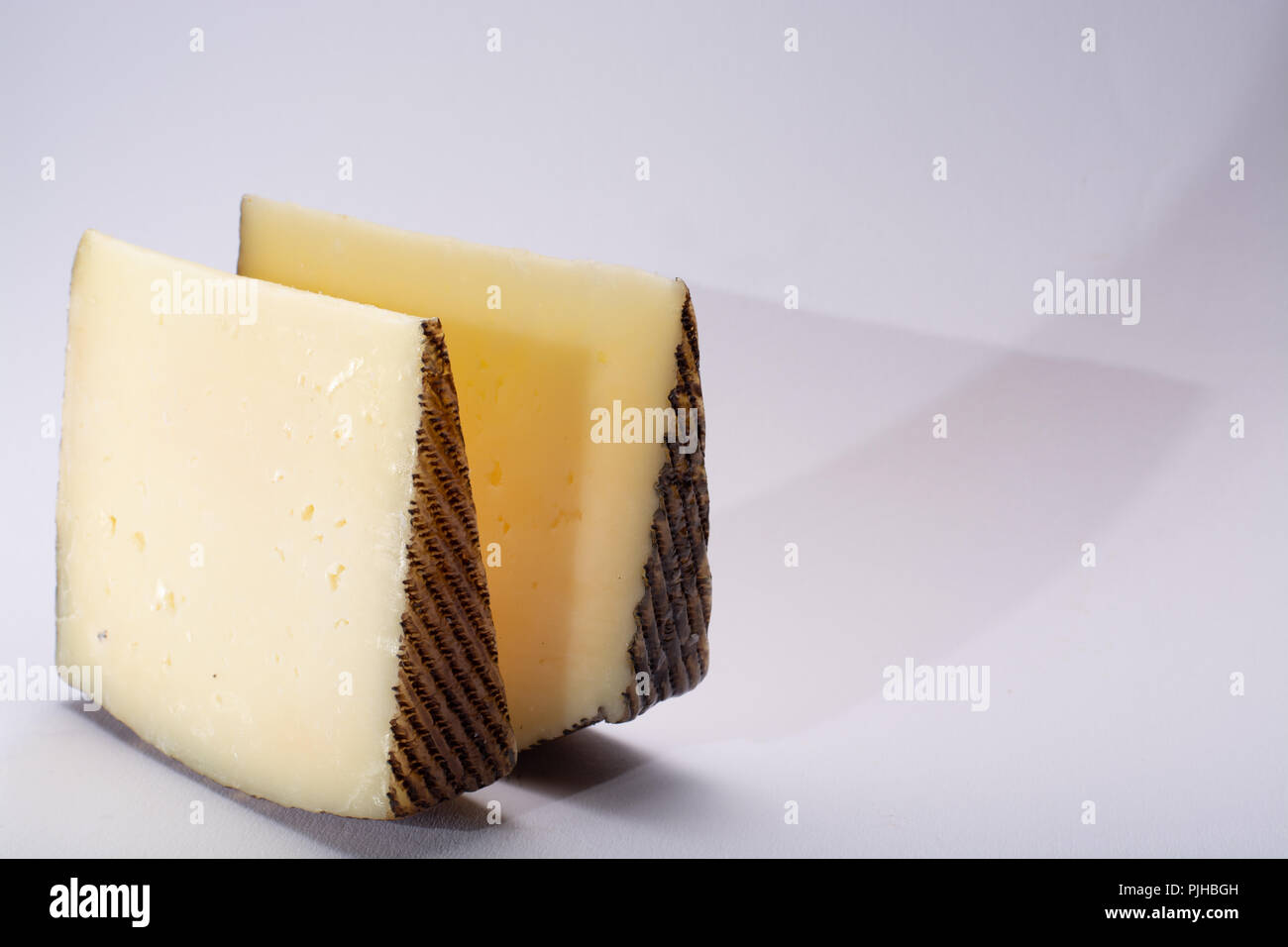 Two pieces of Manchego, queso manchego, cheese made in La Mancha region ...