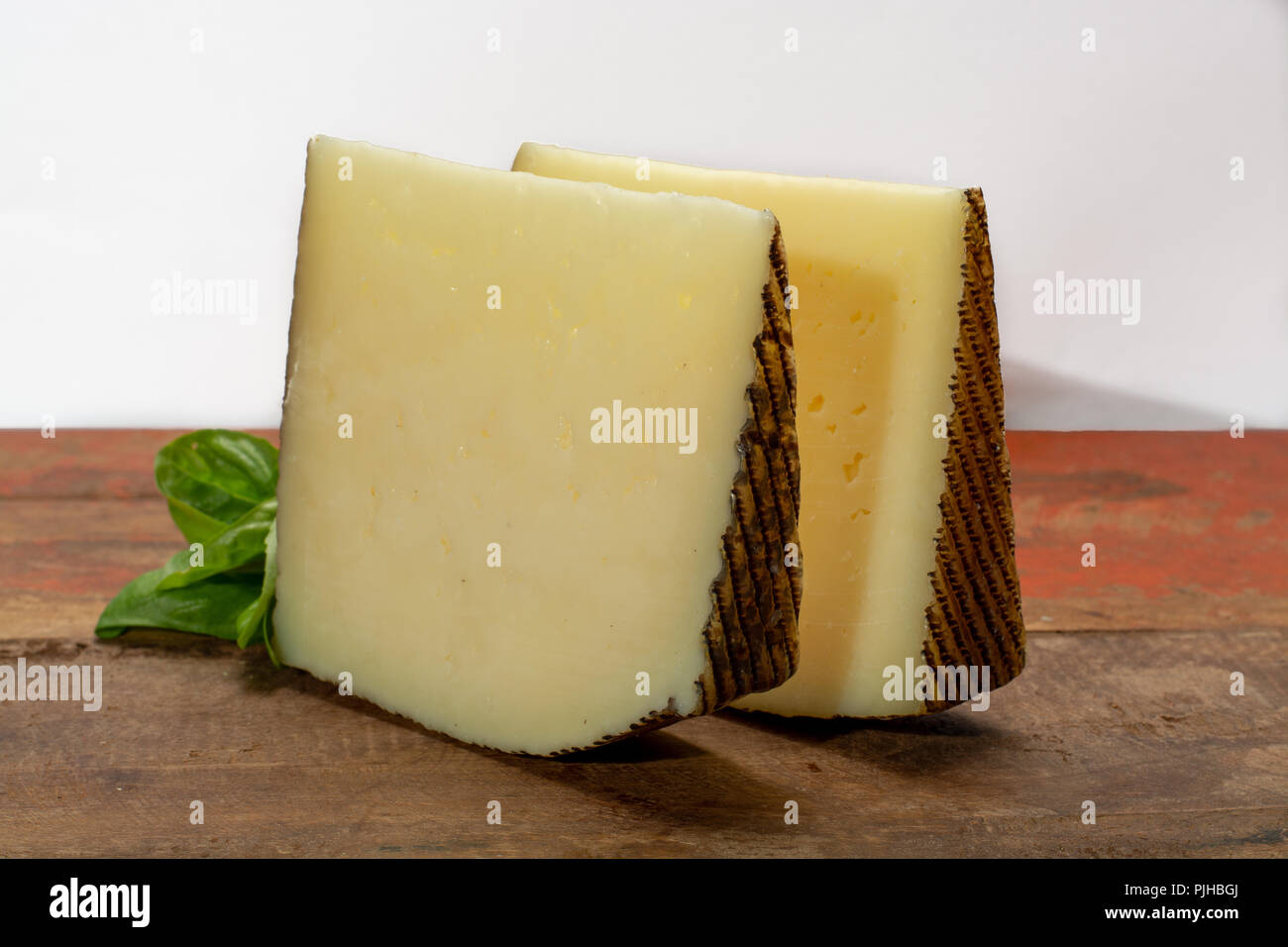 Two pieces of Manchego, queso manchego, cheese made in La Mancha region ...