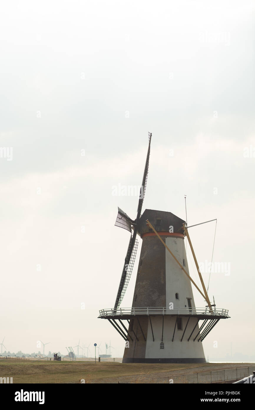 Tourist destination, traditional Dutch windmill on sea shore ...