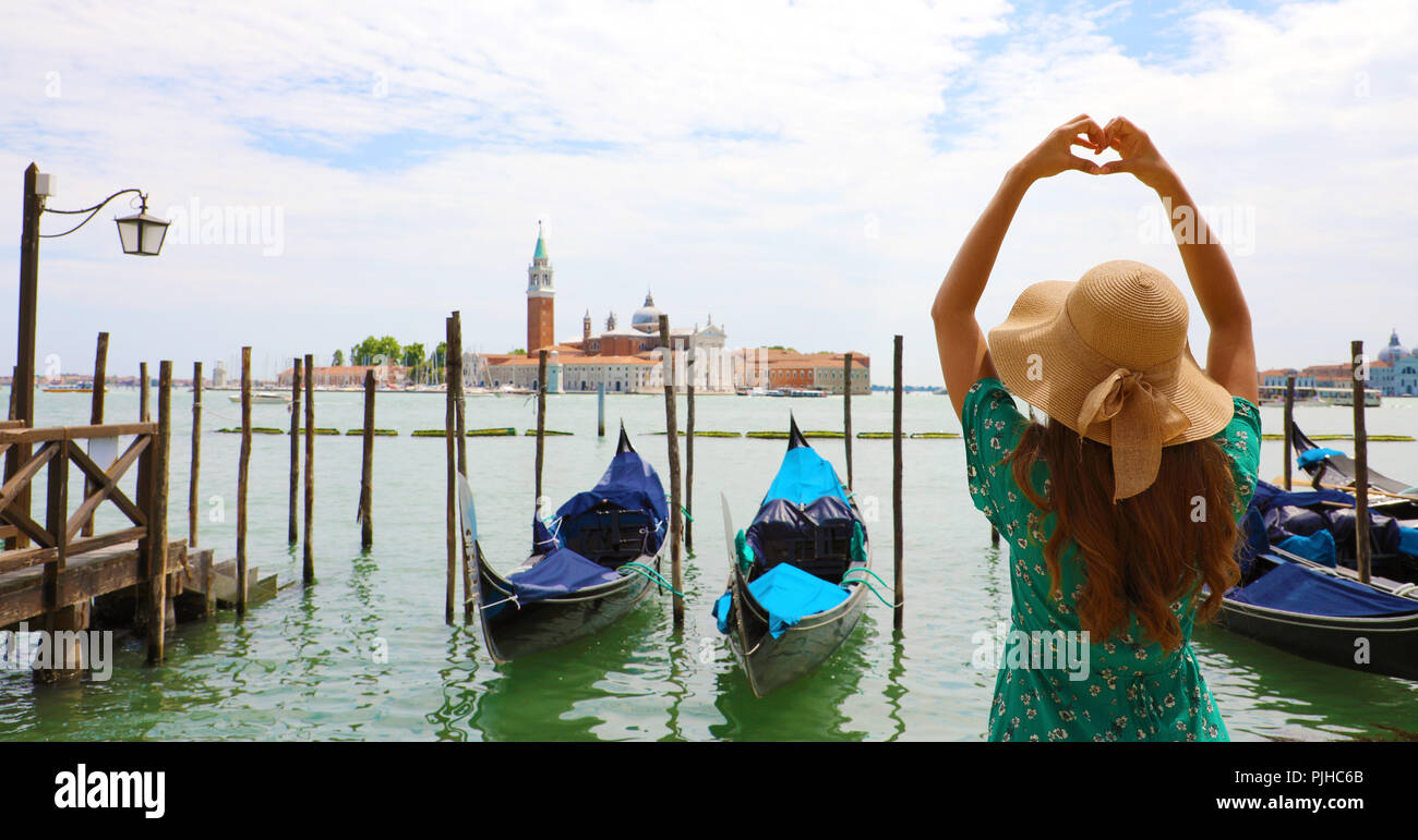 Woman making heart shape with hands on the beautiful view of Venice ...