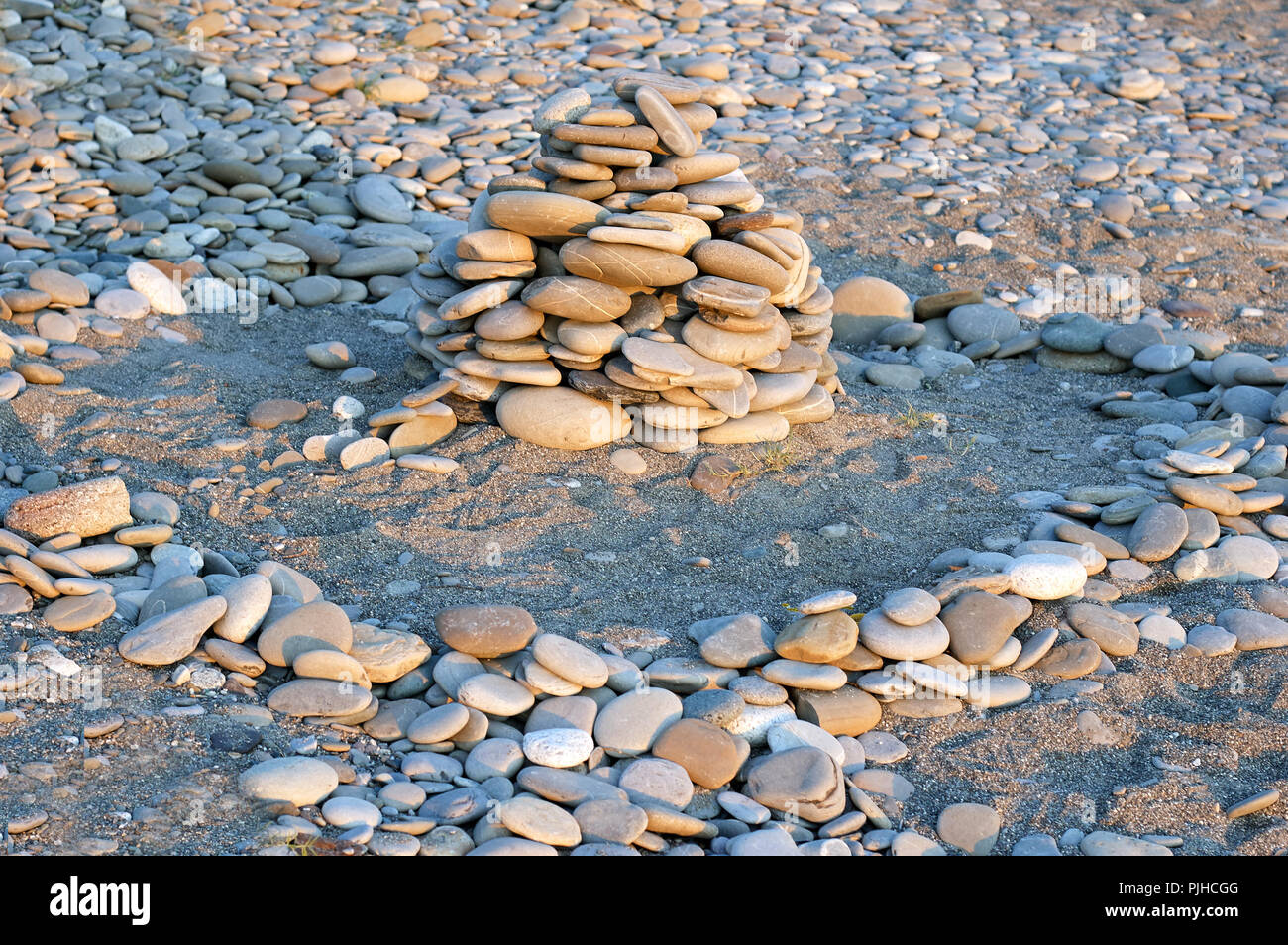stone pyramid on the sand beach Stock Photo - Alamy