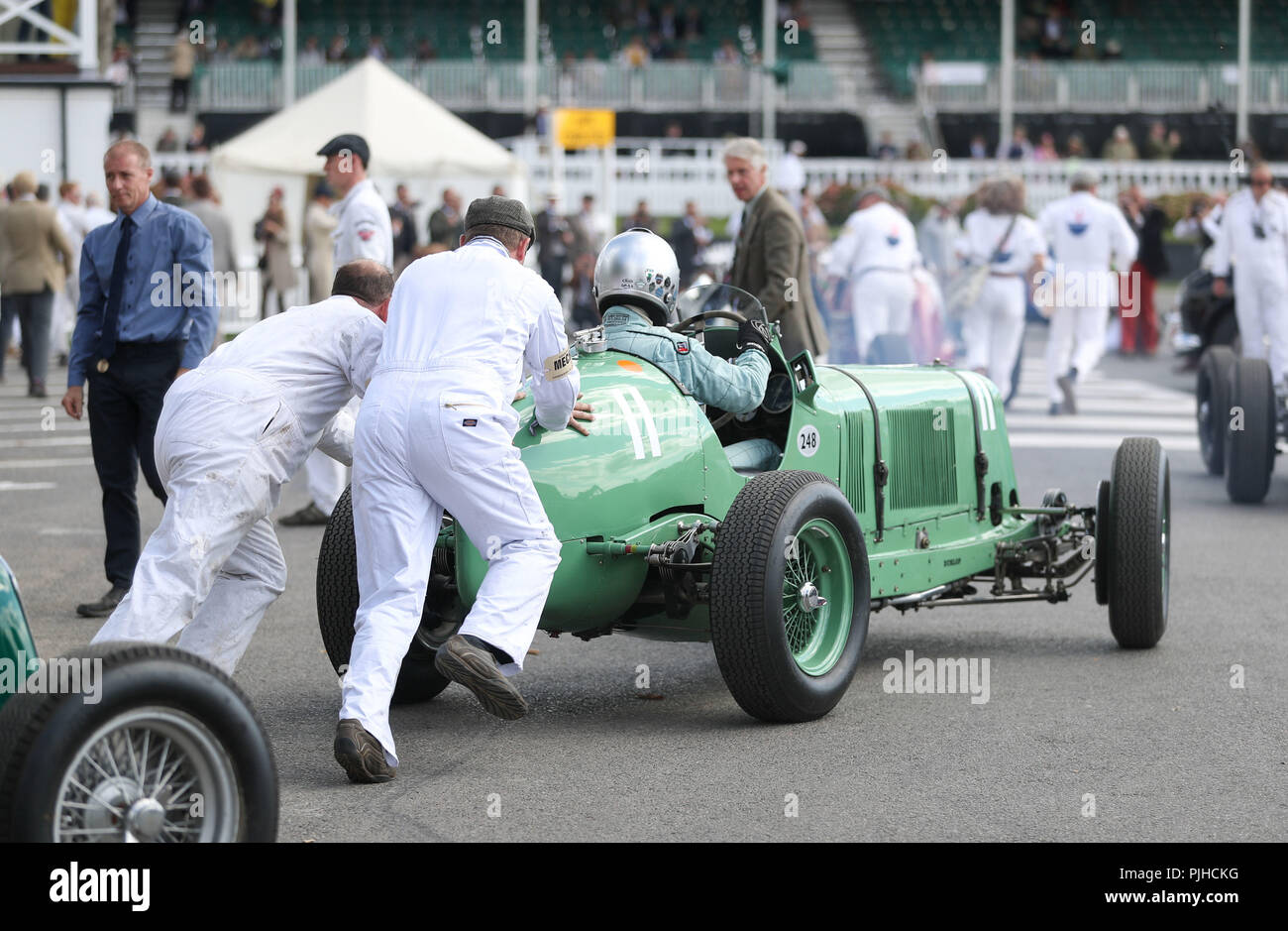Mechanics push start an ERA R3A at the start of official practice for ...