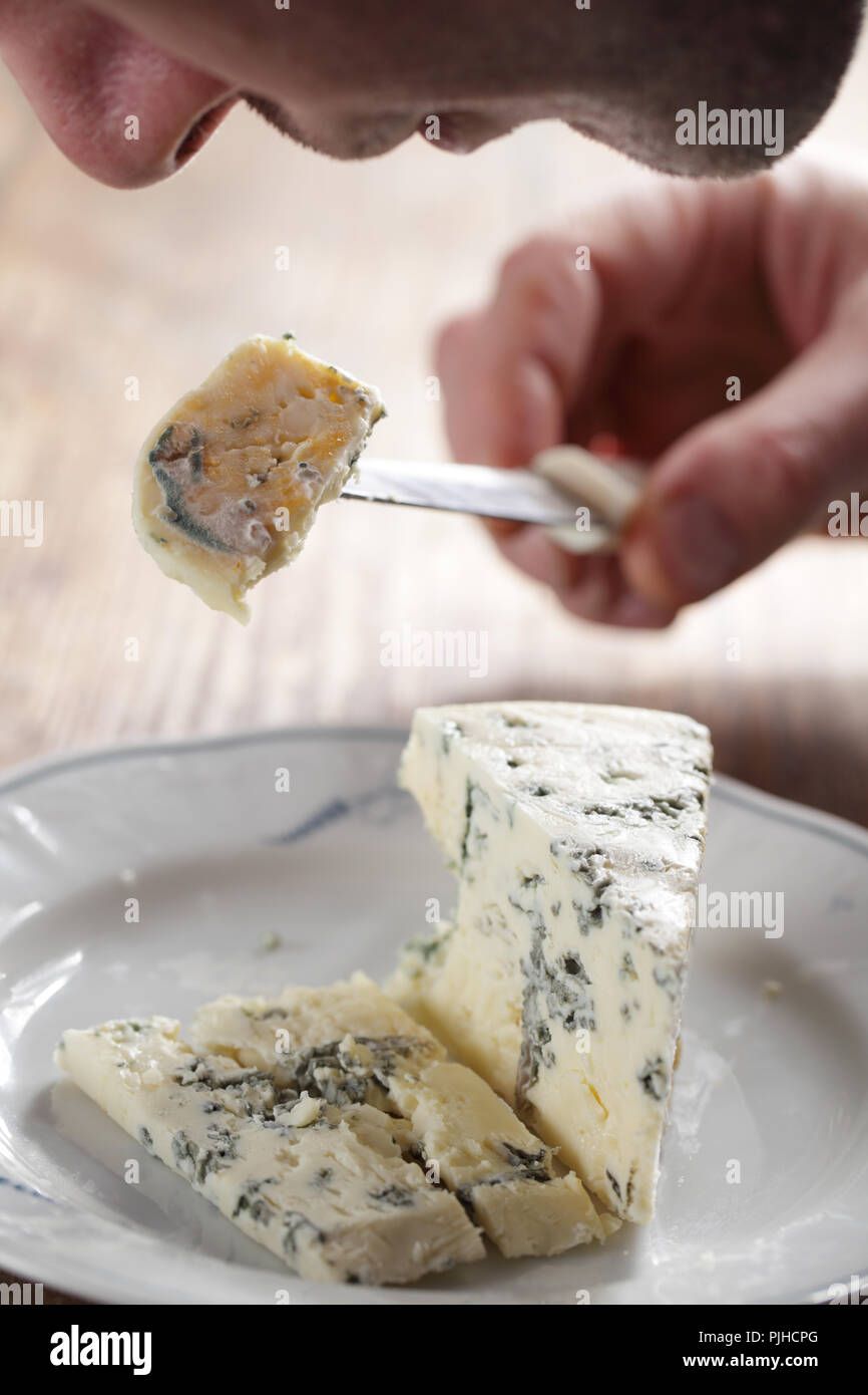 Man smelling the blue cheese Stock Photo - Alamy