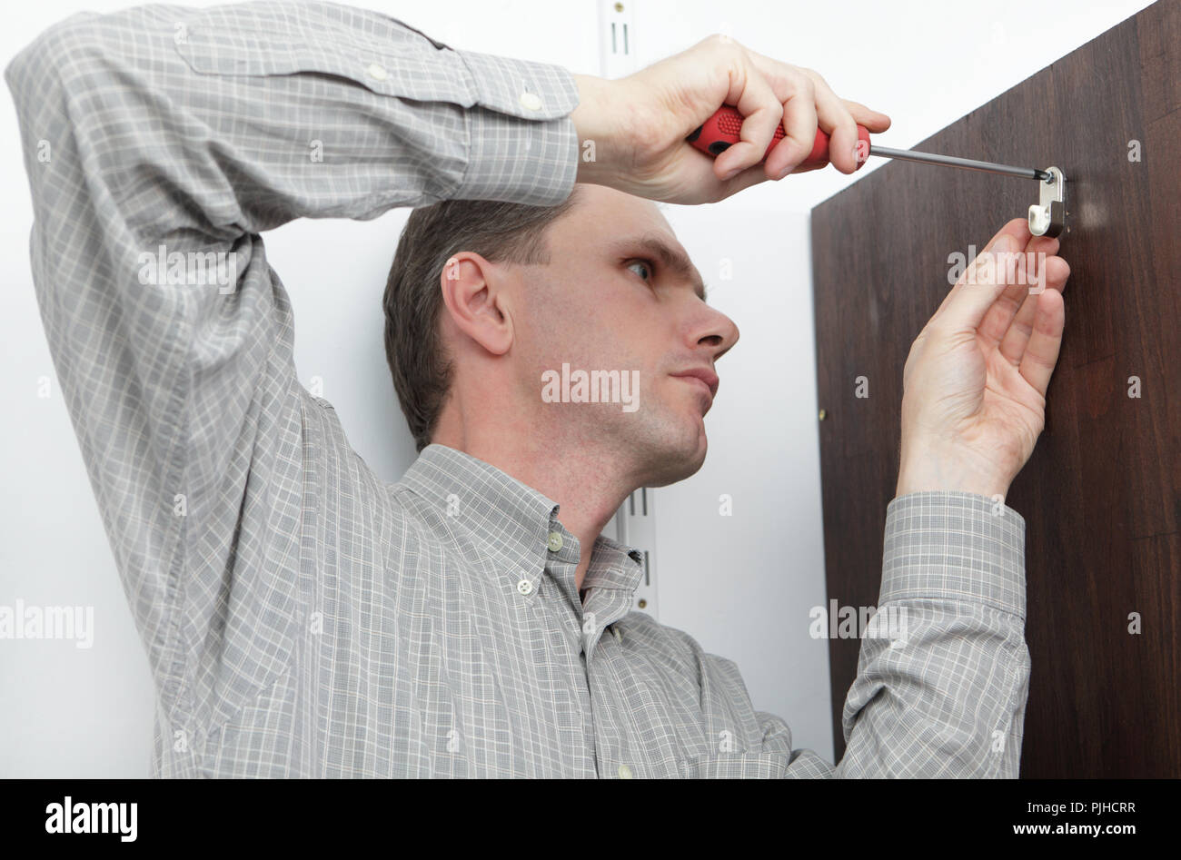 Worker twists in screw hi-res stock photography and images - Alamy