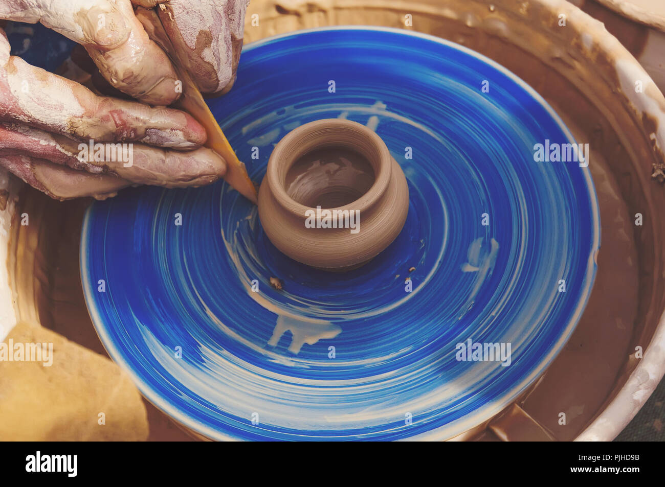 The man - Potter from the clay pitcher on a Potter's wheel. The old ...