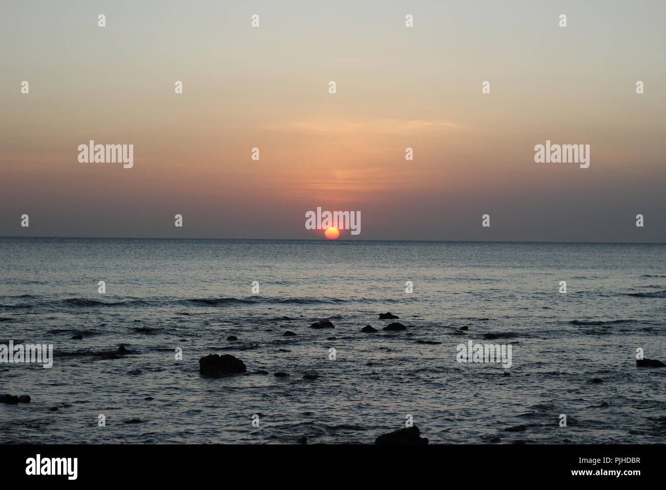 sunset over ocean Stock Photo - Alamy
