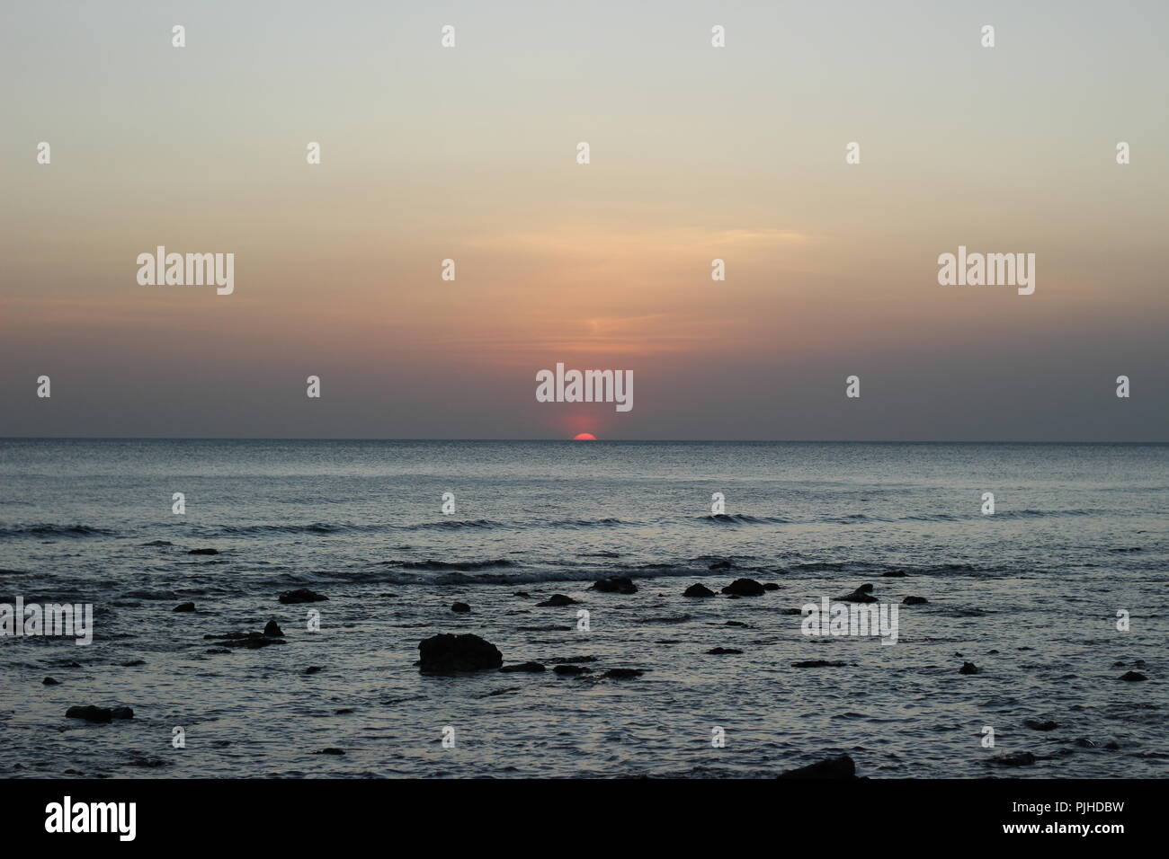sunset over ocean Stock Photo - Alamy