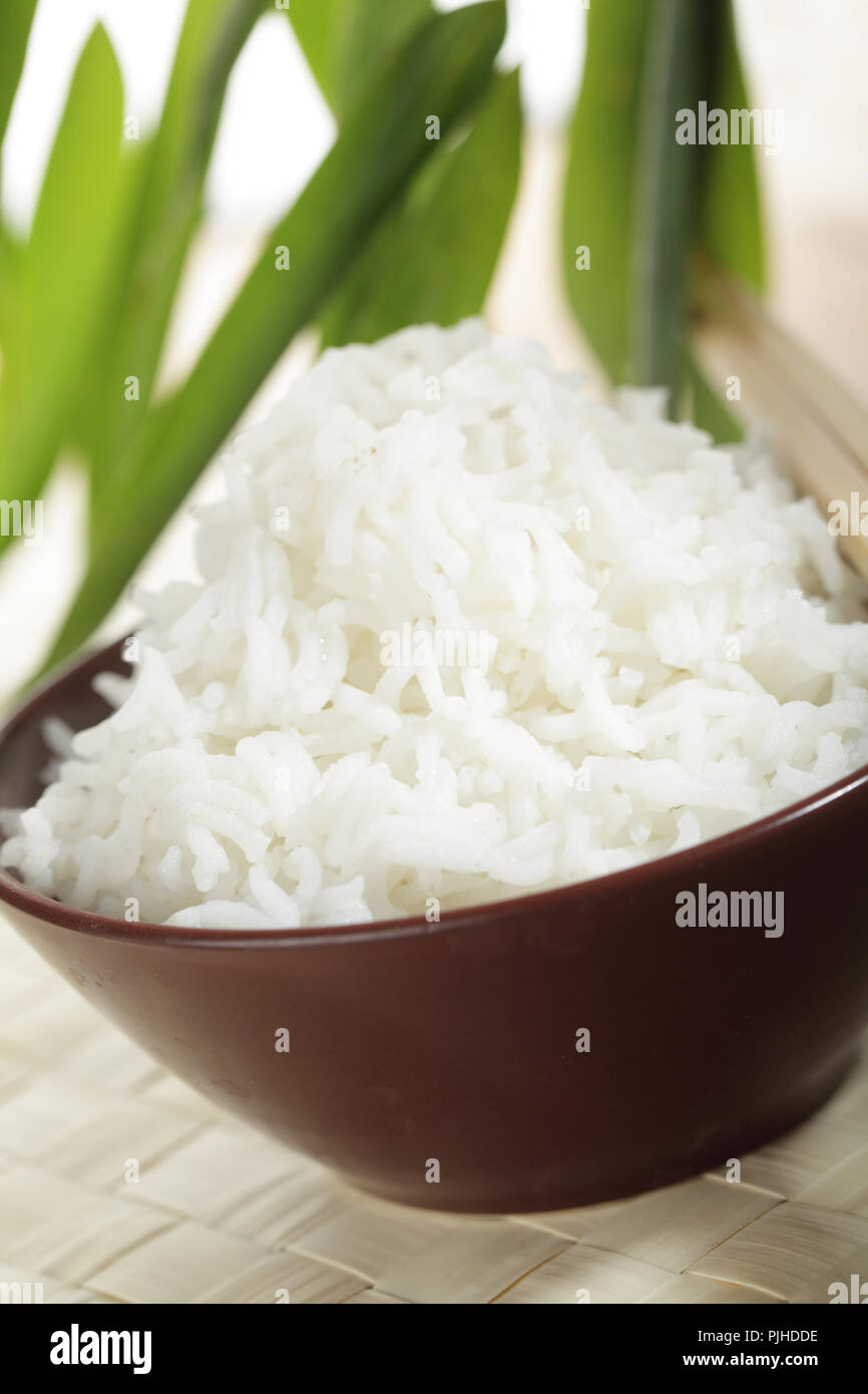 Bowl with prepared rice under bamboo branch Stock Photo - Alamy