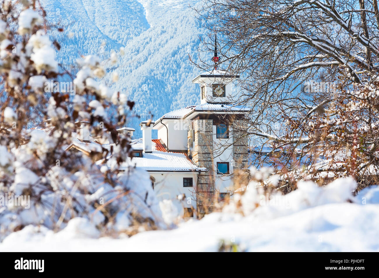 Wooden chalet with tower and snow mountains panorama in bulgarian ski ...