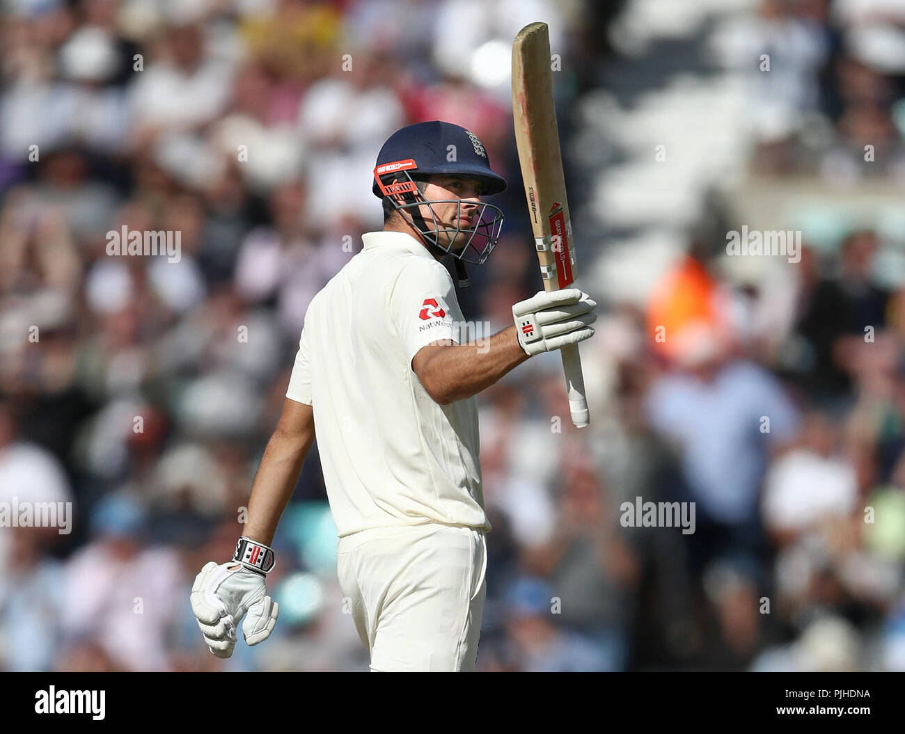 England's Alastair Cook acknowledges the crowd after reaching his half ...
