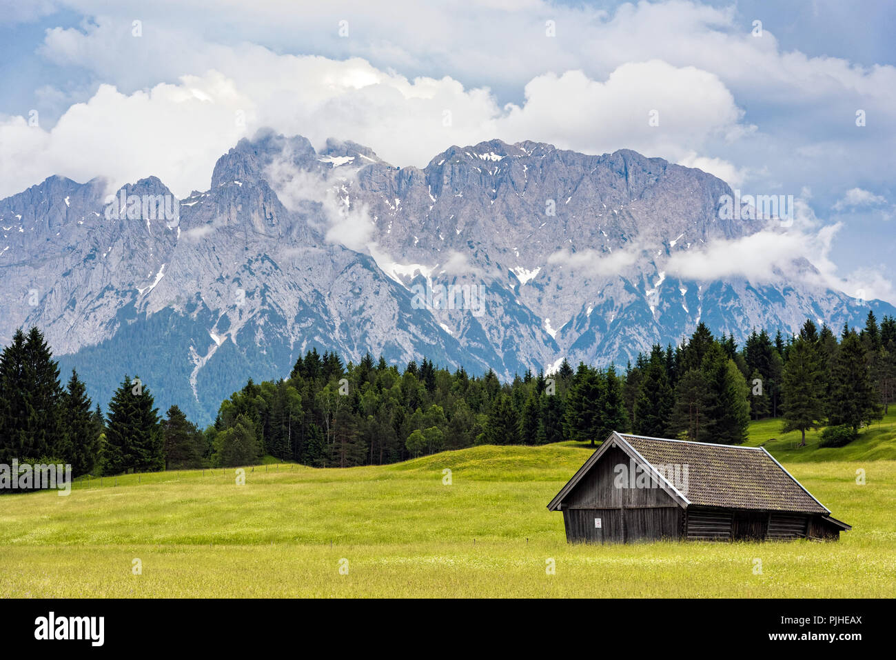Wooden hut near Zugspitze, the highest mountain of Germany at the ...