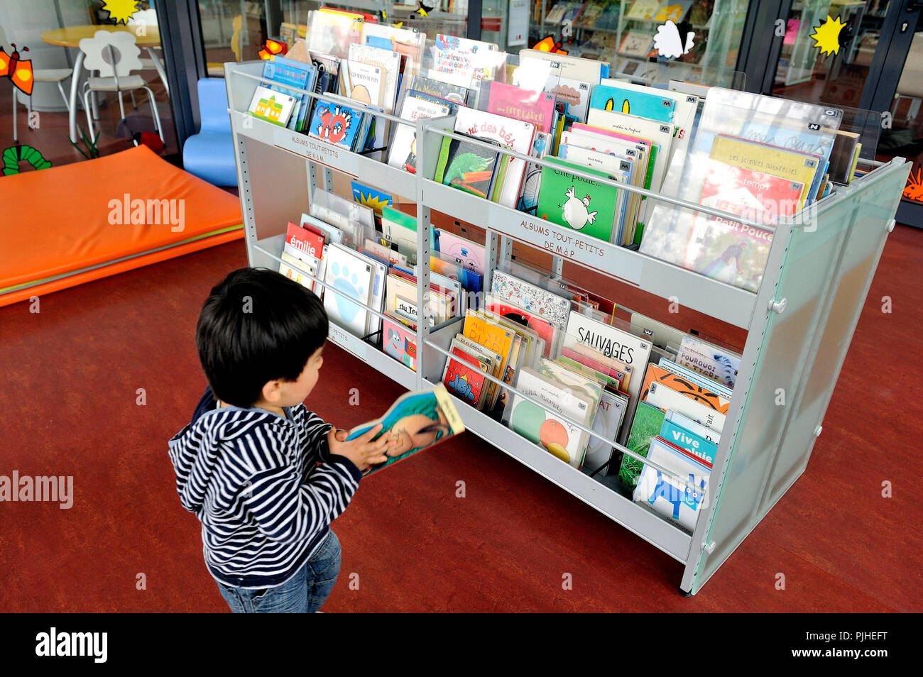 Two-year-old little boy at the media library Stock Photo - Alamy