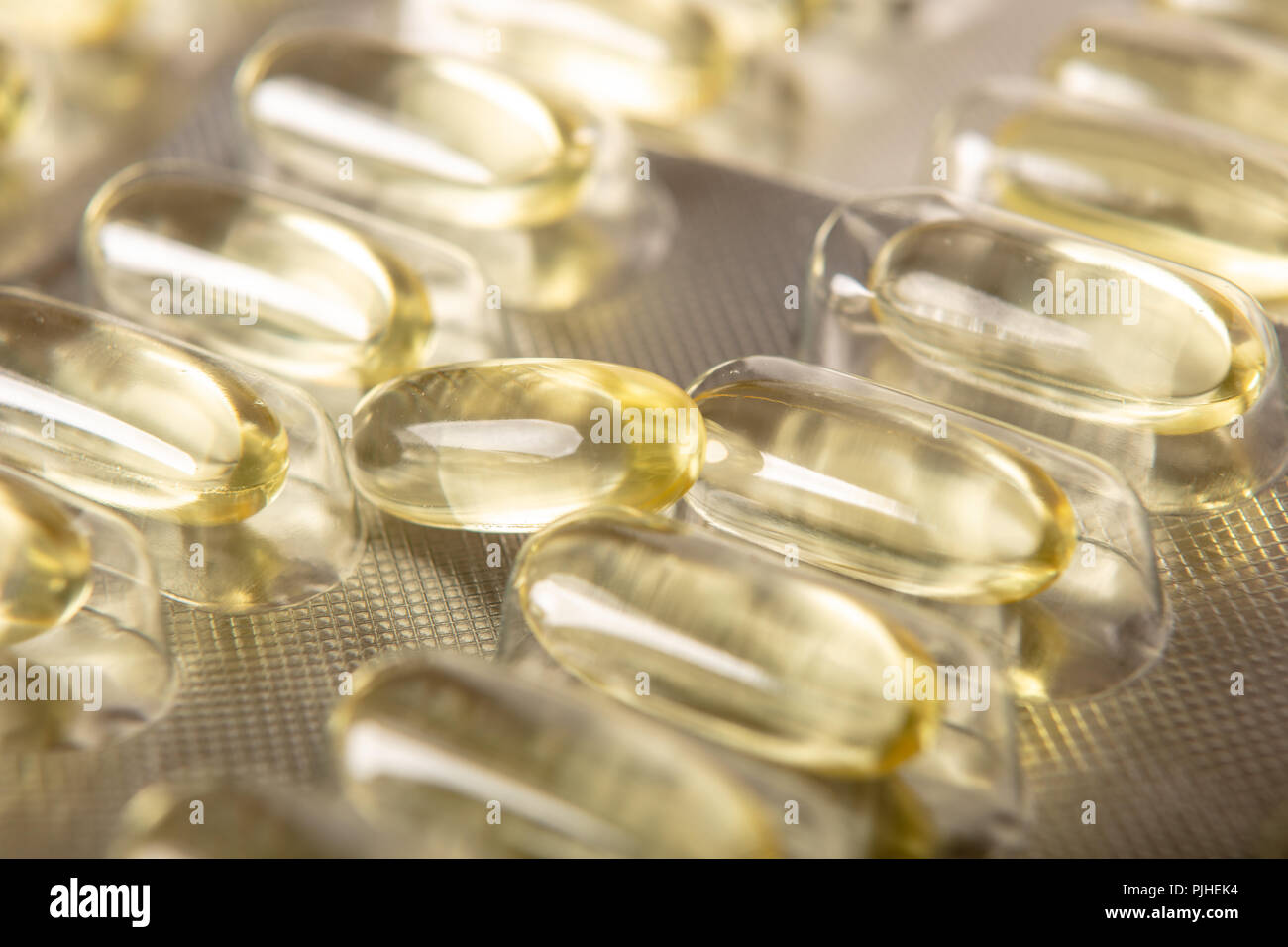 Yellow color vitamin pills with omega 3 , epa and dha . Fish oil ...
