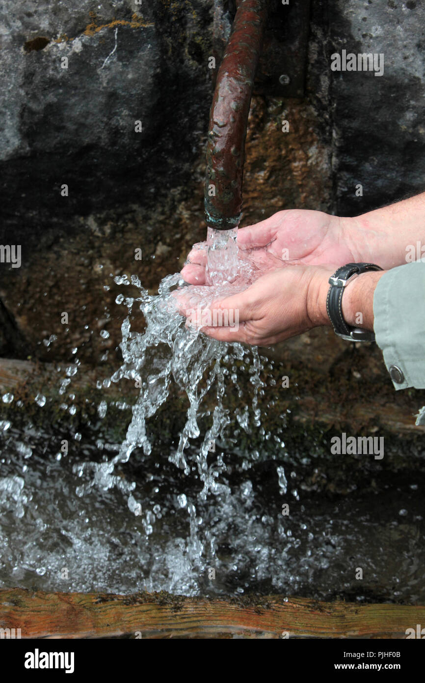 Drink spring water in a fountain. France Stock Photo - Alamy