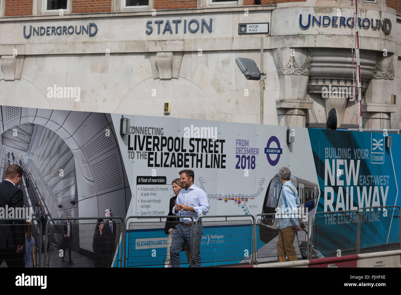 Londoners and commuters walk past the billboards promoting Crossrail's ...
