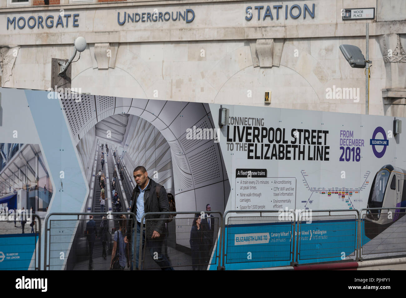 Londoners and commuters walk past the billboards promoting Crossrail's ...