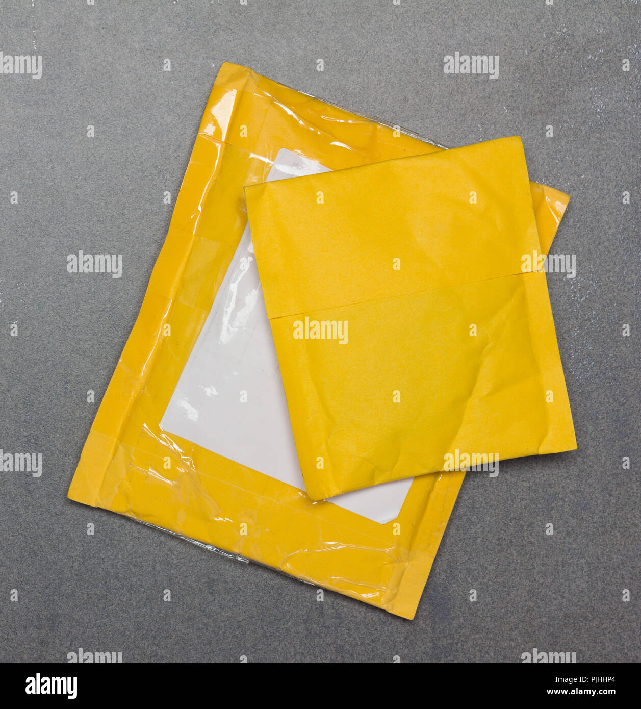 yellow paper package from Chinese online stores on grey background, top ...