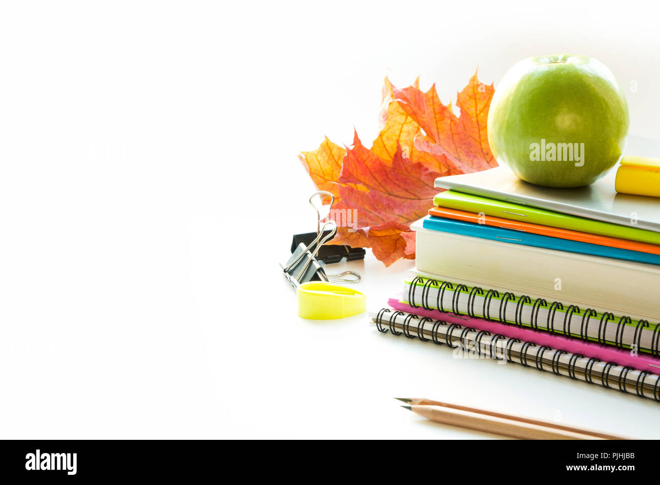 Colorful school supplies, book, apple on white. Close up. Back to ...