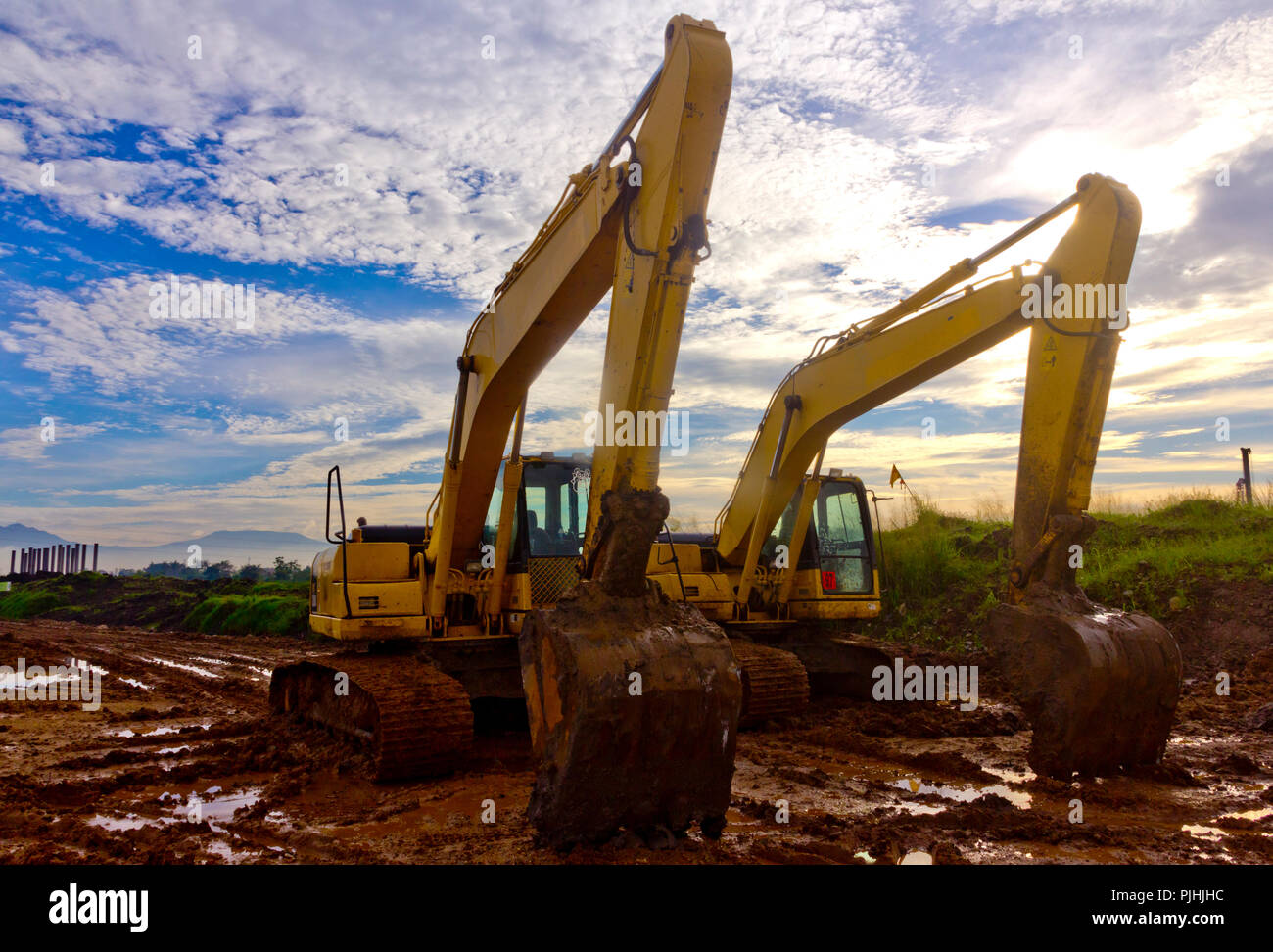 Excavator at sunset landscape Stock Photo - Alamy