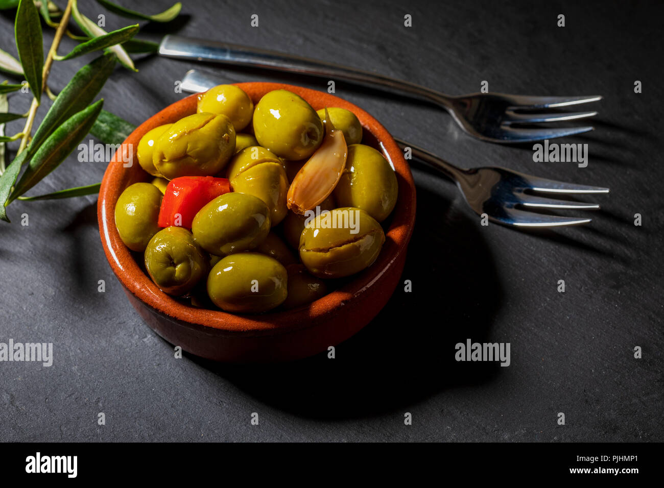 Clay pot with artisan olives (preserved in extra virgin olive oil ...