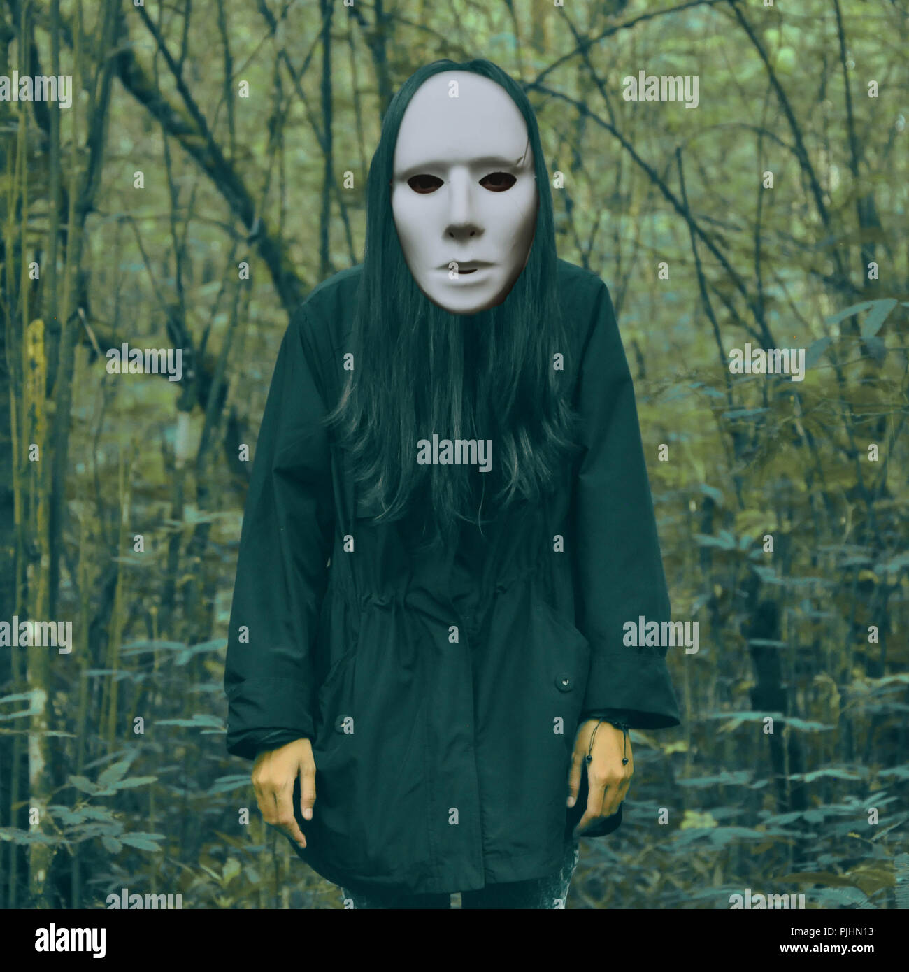 Halloween scary masked women in a creepy forest landscape Stock Photo ...