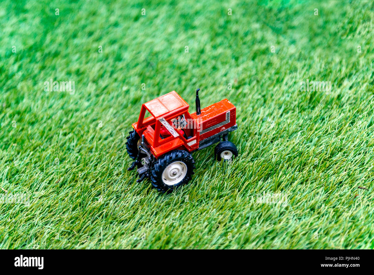 Toy tractor on grass hi-res stock photography and images - Alamy