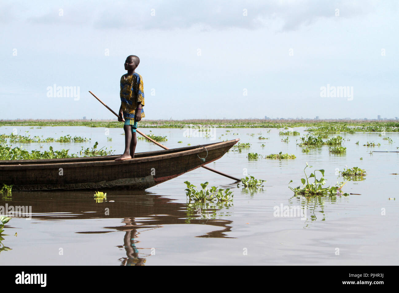 Beninese child standing on a canoe. Lake Nokoue. Ganvie. Benin Stock ...