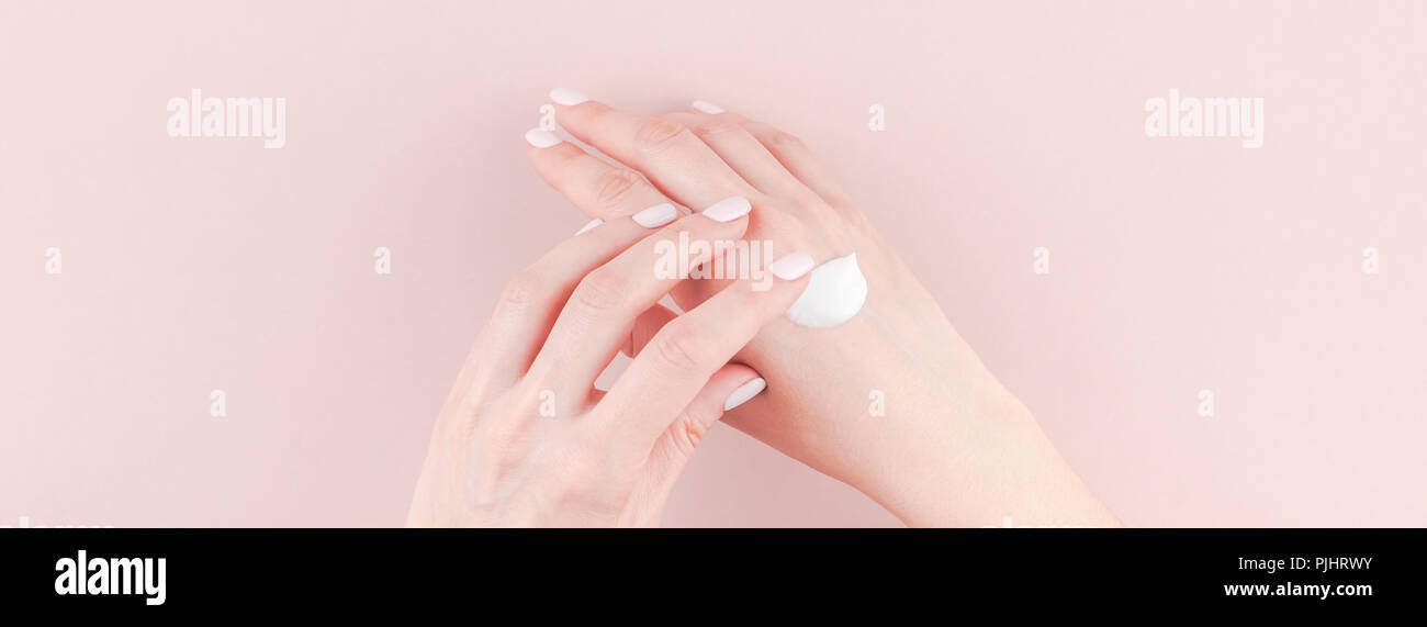 Long wide banner of woman moisturizing her hand with cosmetic cream ...