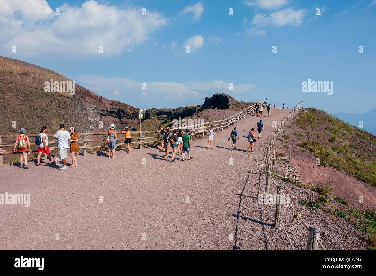 MOUNT VESUVIUS, ITALY - AUGUST 1, 2018: Tourists walk around the crater ...