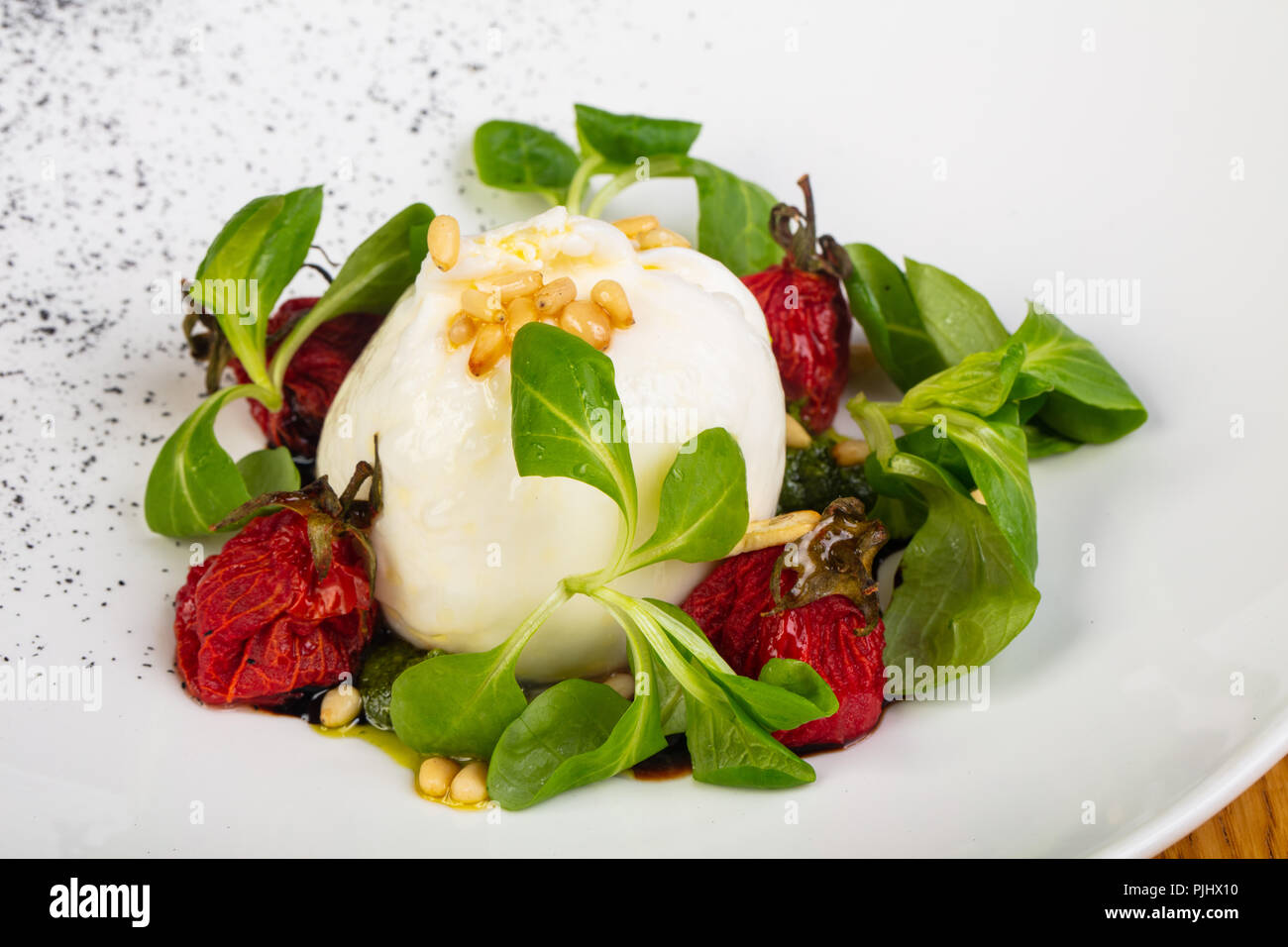 Buratta salad with baked tomatoes Stock Photo - Alamy