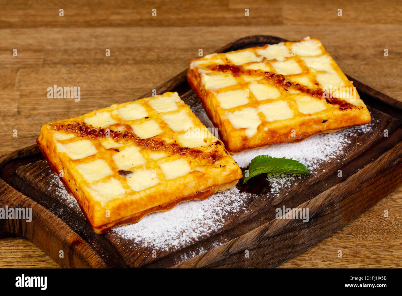 Sweet Belgian Waffer over wooden background Stock Photo - Alamy