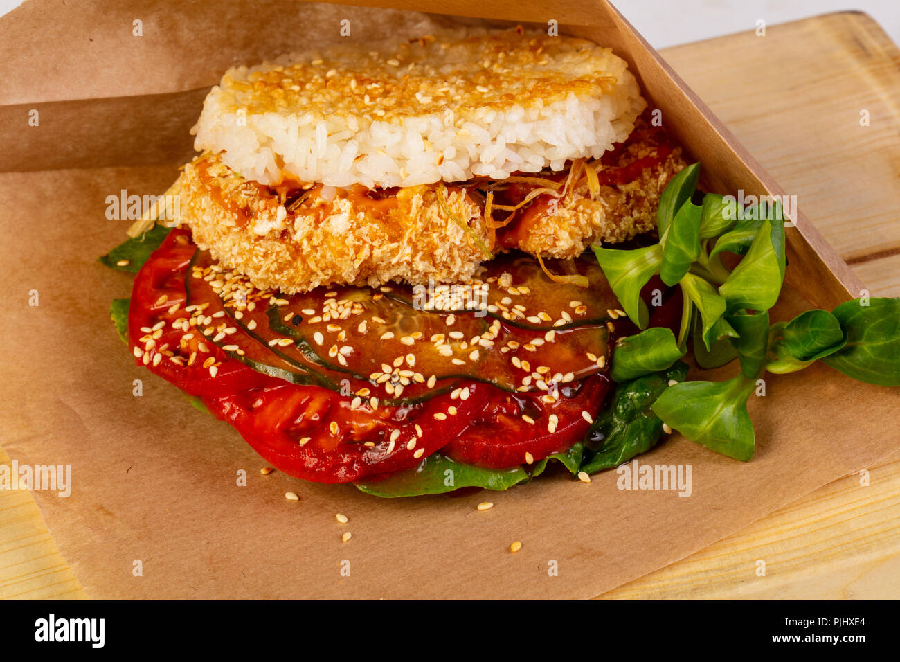 Rice burger with crispy chicken Stock Photo - Alamy