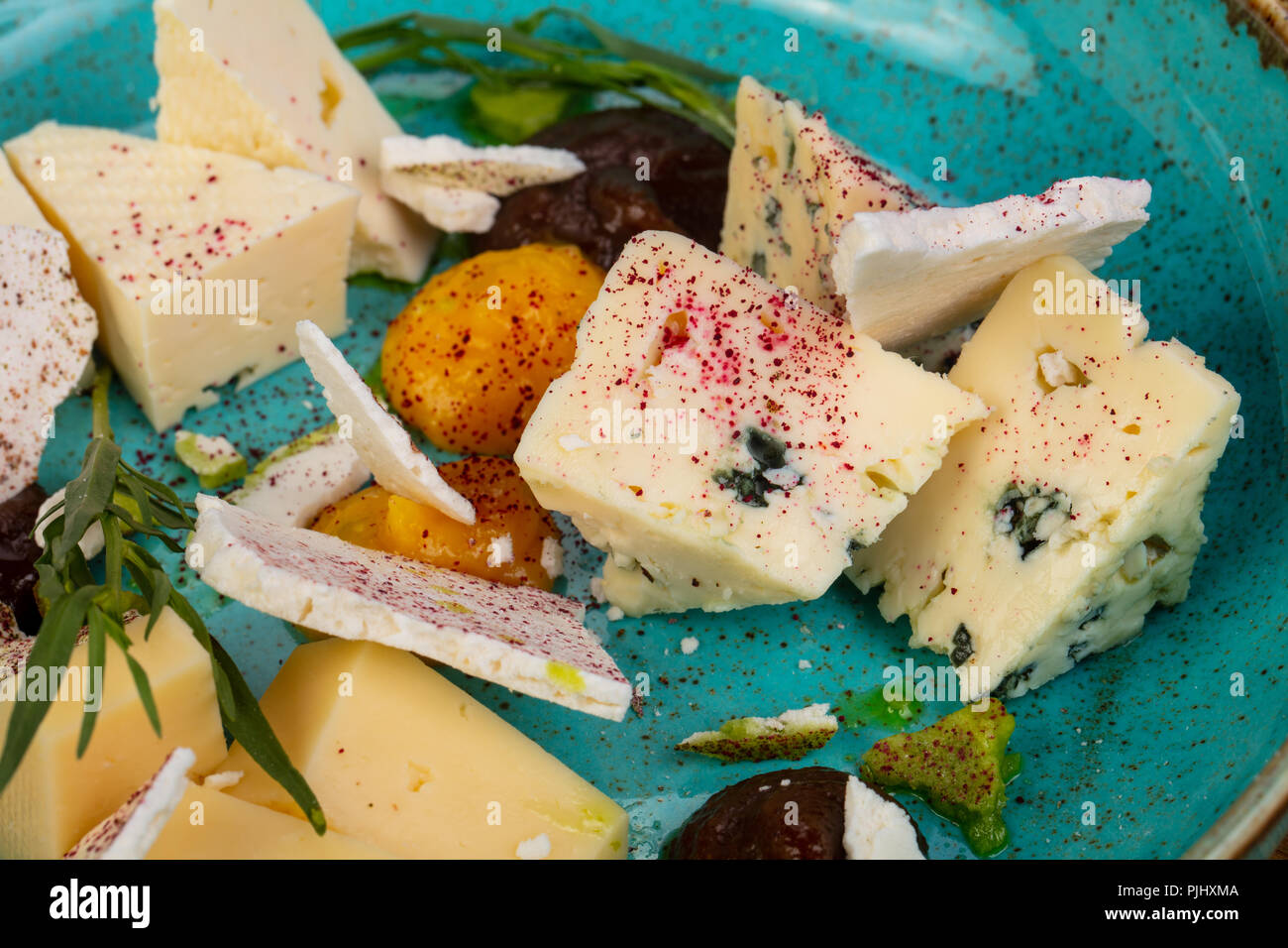 Cheeses plate mix served estragon Stock Photo - Alamy