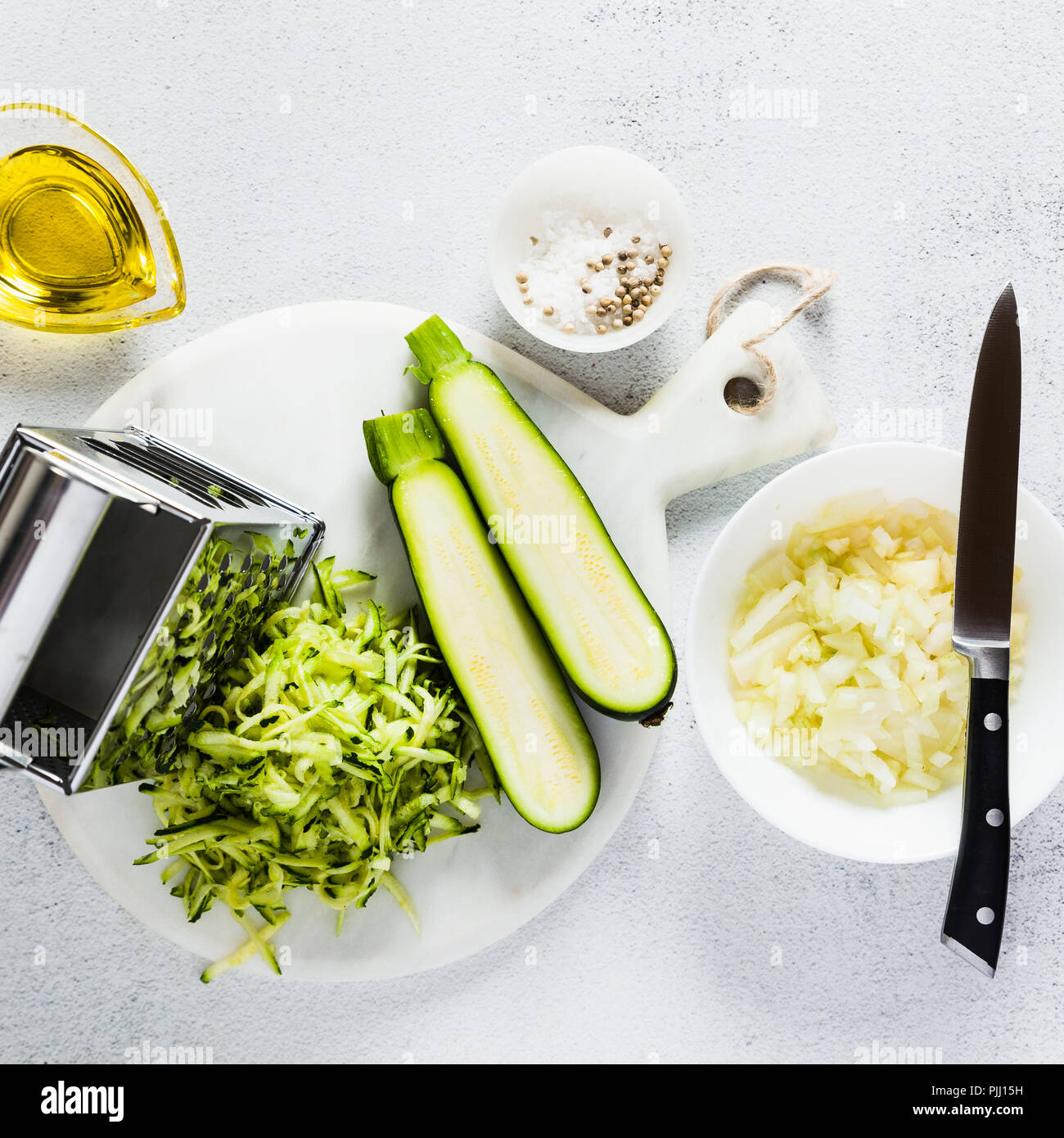 raw ingredients on the table. zucchini grate and finely chopped onions ...