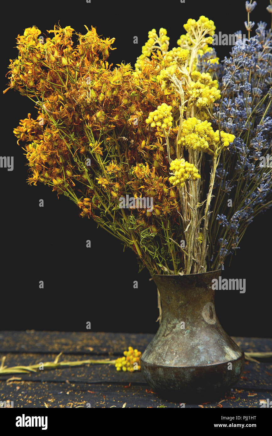 Dry herbs flower in vase - tutsan, sagebrush, oregano, helichrysum ...