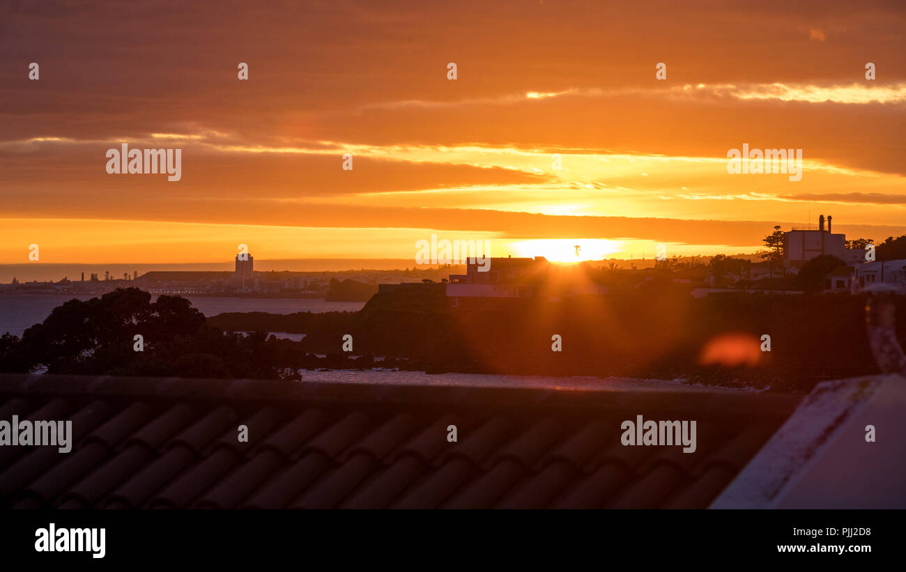Sunset Over The Roofs Stock Photo - Alamy