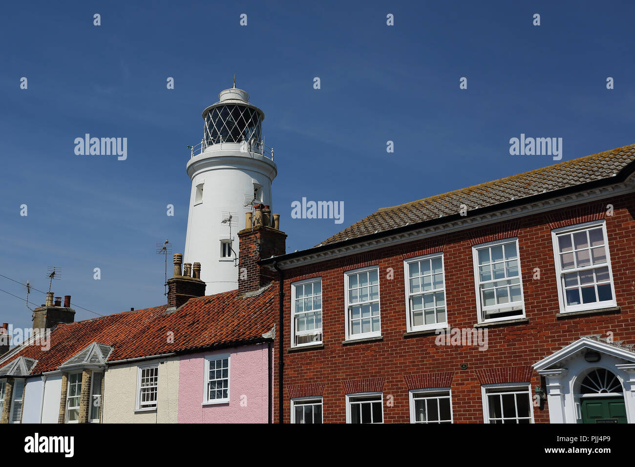 The Trinity House Lighthouse towers above local houses at Southwold ...