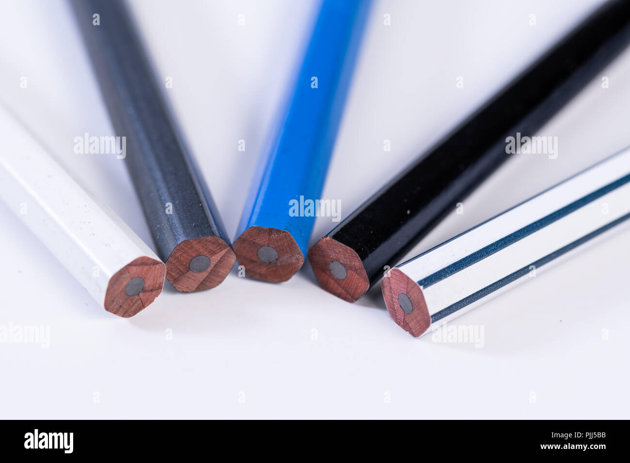 Several unsharpened new graphite pencils of different colors and ...