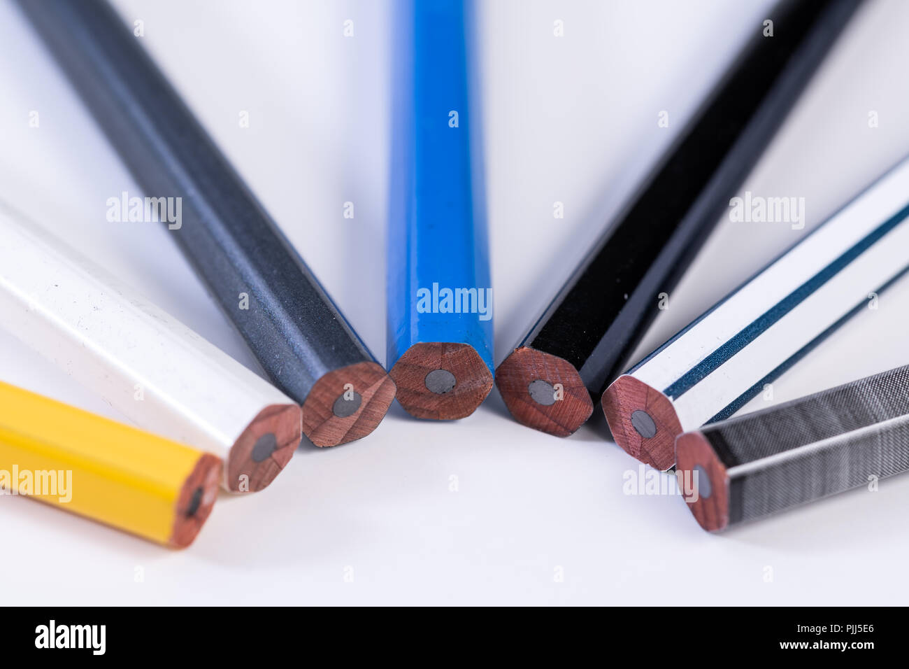 Several unsharpened new graphite pencils of different colors and ...