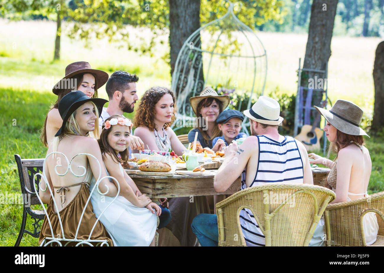 Group of young people seated at a brunch in the country. Mandatory ...