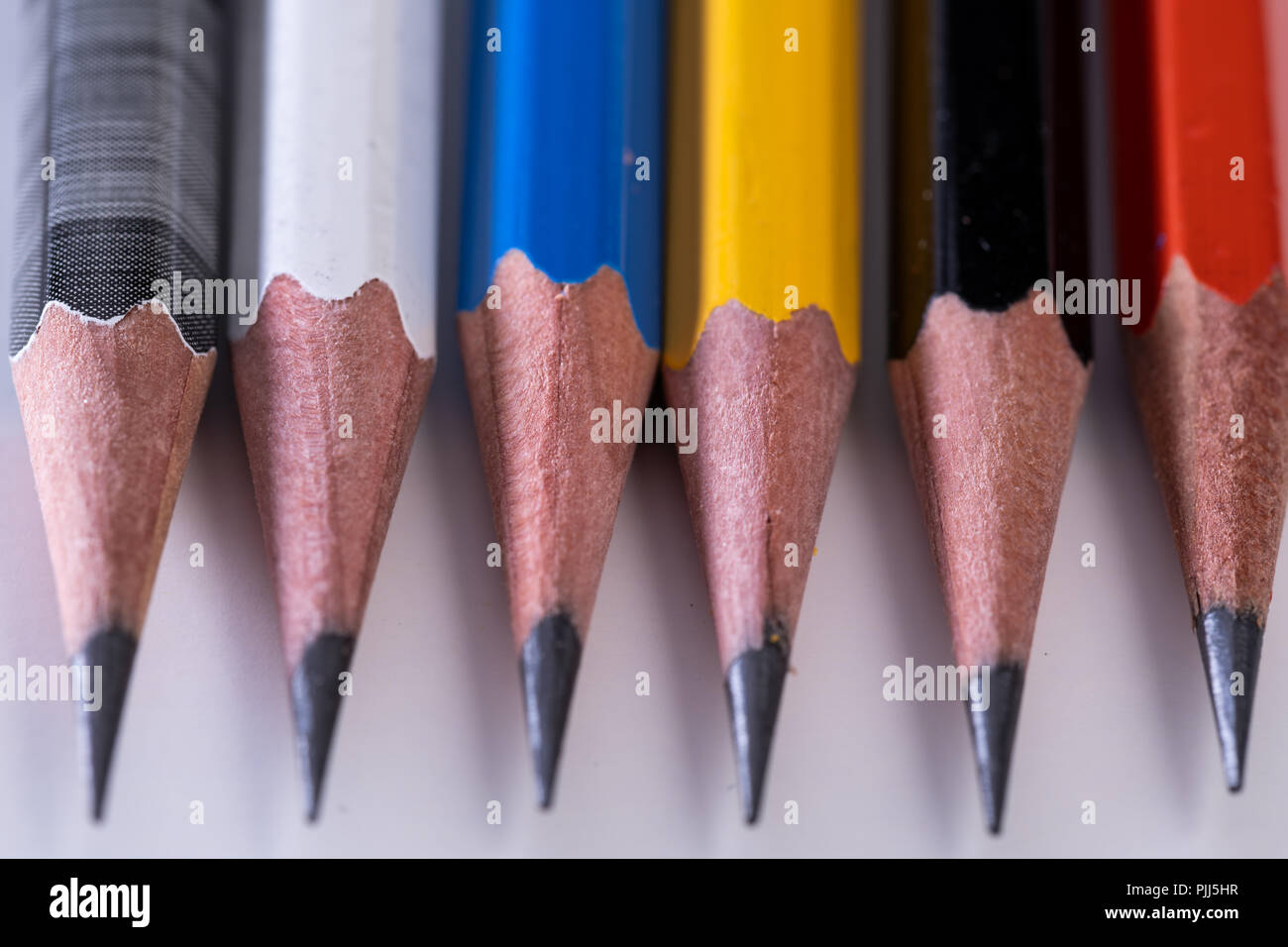 Several sharp new lead graphite pencils of various colors and patterns ...