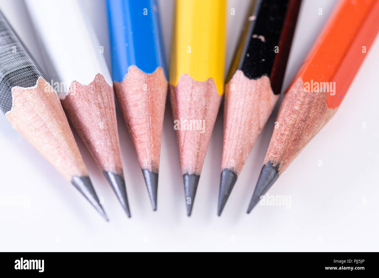 Several sharp new lead graphite pencils of various colors and patterns ...