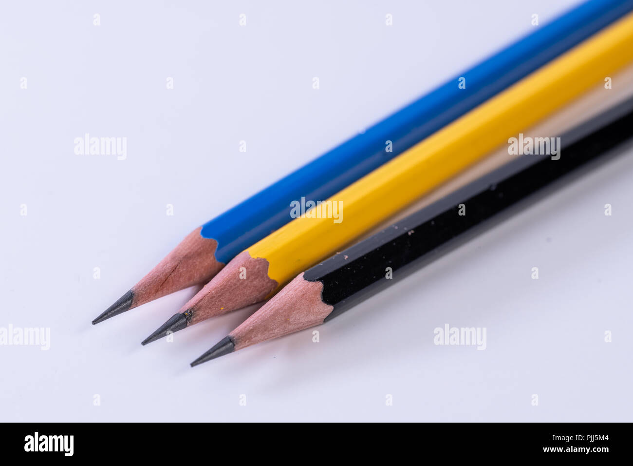 Several sharp new lead graphite pencils of various colors and patterns ...