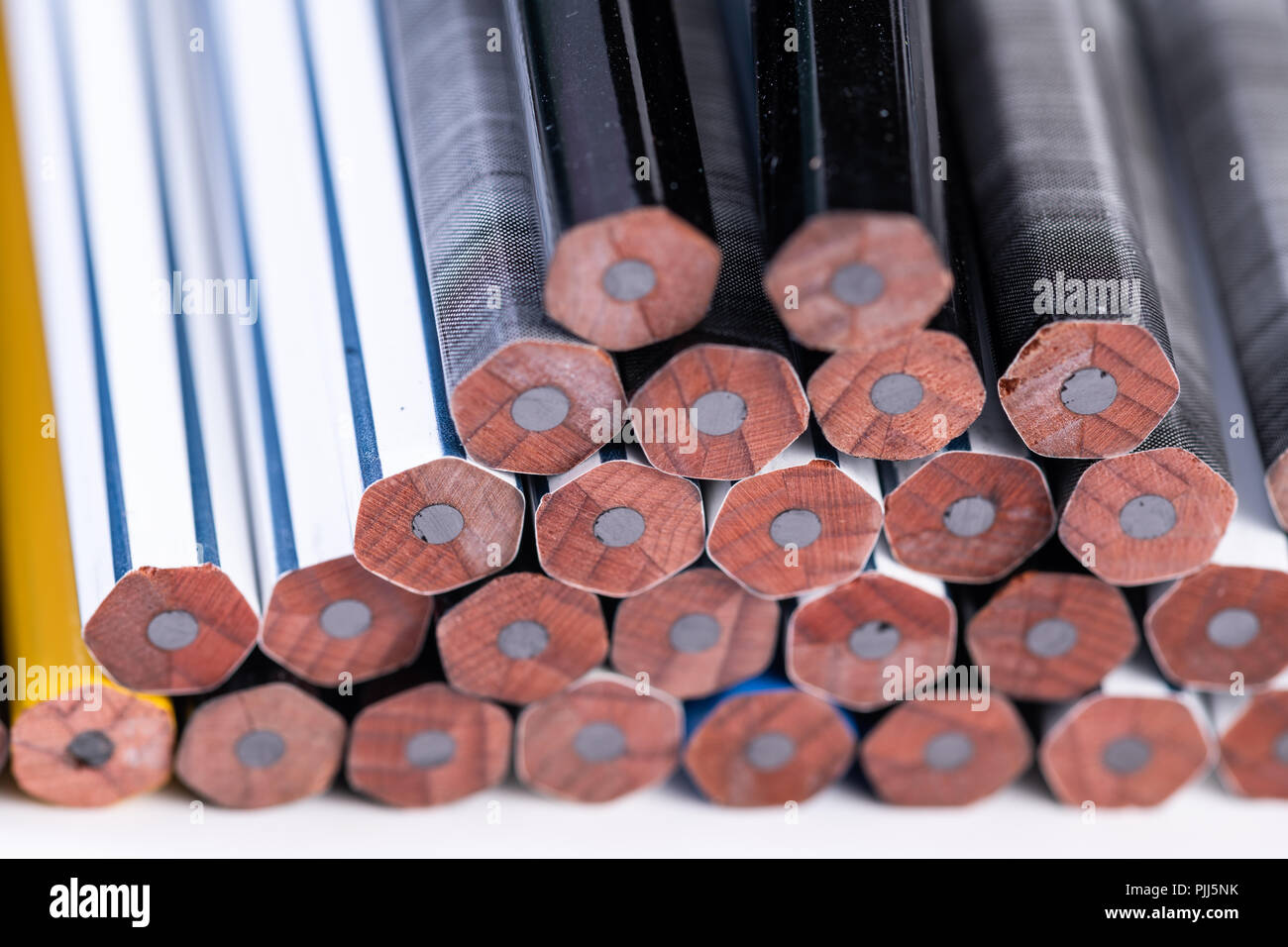 Several unsharpened new graphite pencils of different colors and ...