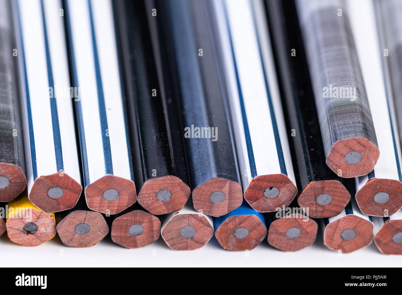 Several unsharpened new graphite pencils of different colors and ...