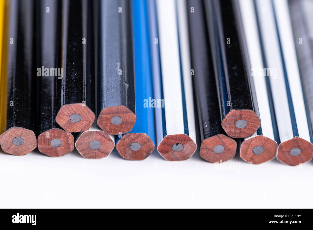 Several unsharpened new graphite pencils of different colors and ...